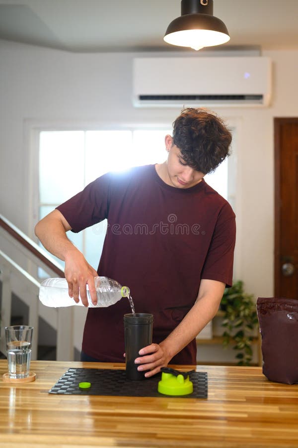 Athletic Male Preparing a Protein Shake in a Modern Kitchen Stock Photo ...