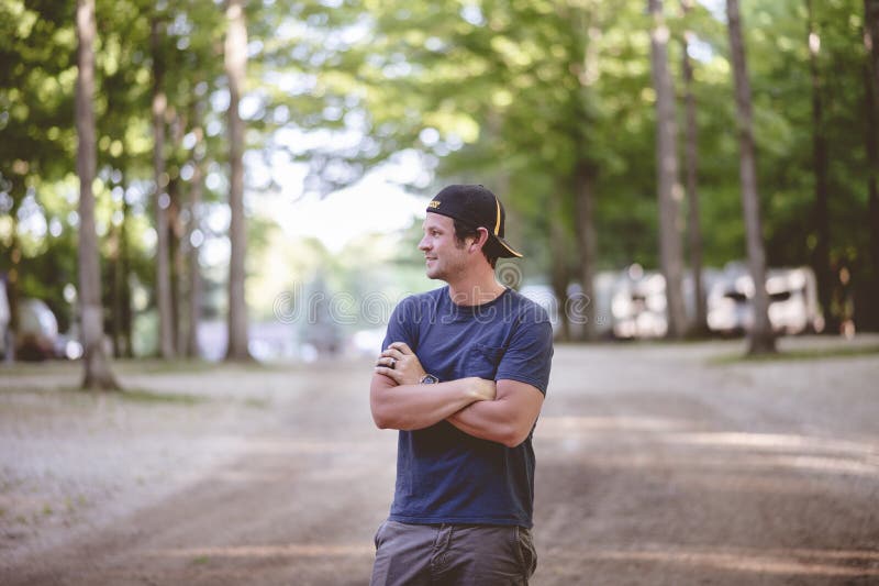 Athletic Male Wearing a Cap Standing in the Middle of a Park Stock ...