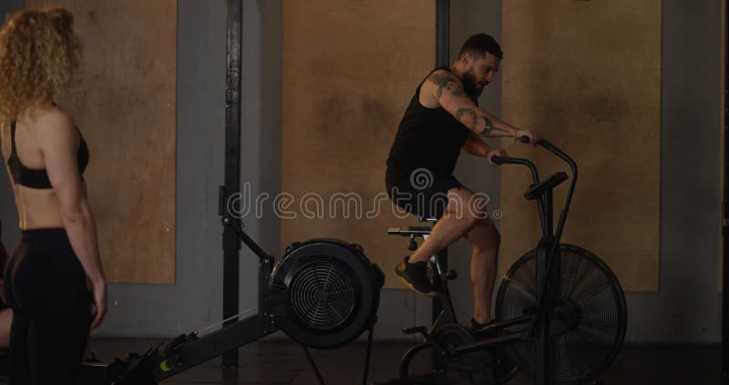 Athletic Man in Black T-shirt Doing Strength Training Exercises in Group and Changing Positions ...