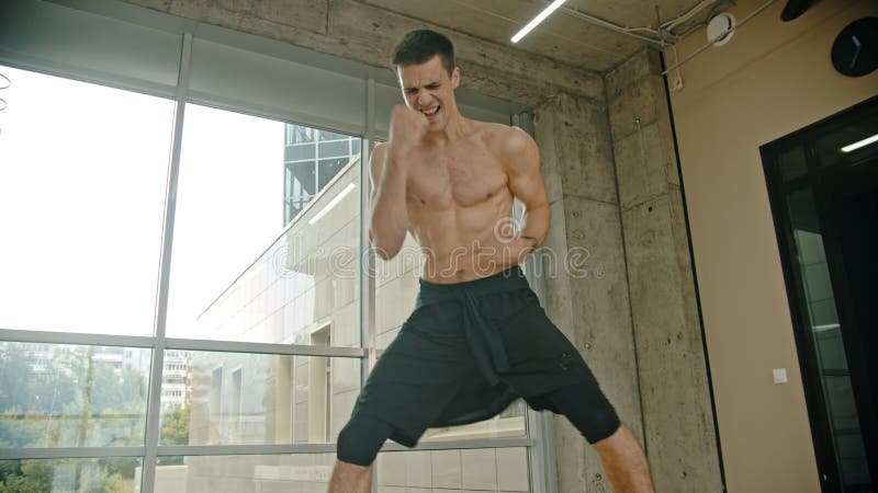 An Athletic Man Boxer Standing by the Window and Performing a Fight ...