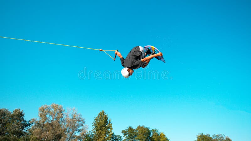 Athletic Man Does a Cool Spinning Backflip while Wakesurfing at the ...