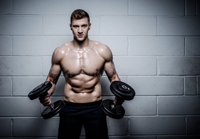 Athletic Man Doing Exercises with Dumbbells in the Gym S Stock Image ...