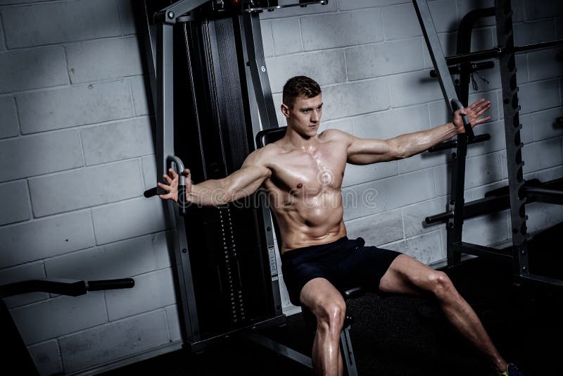 Athletic Man Doing Exercises on Training Apparatus Stock Image - Image ...