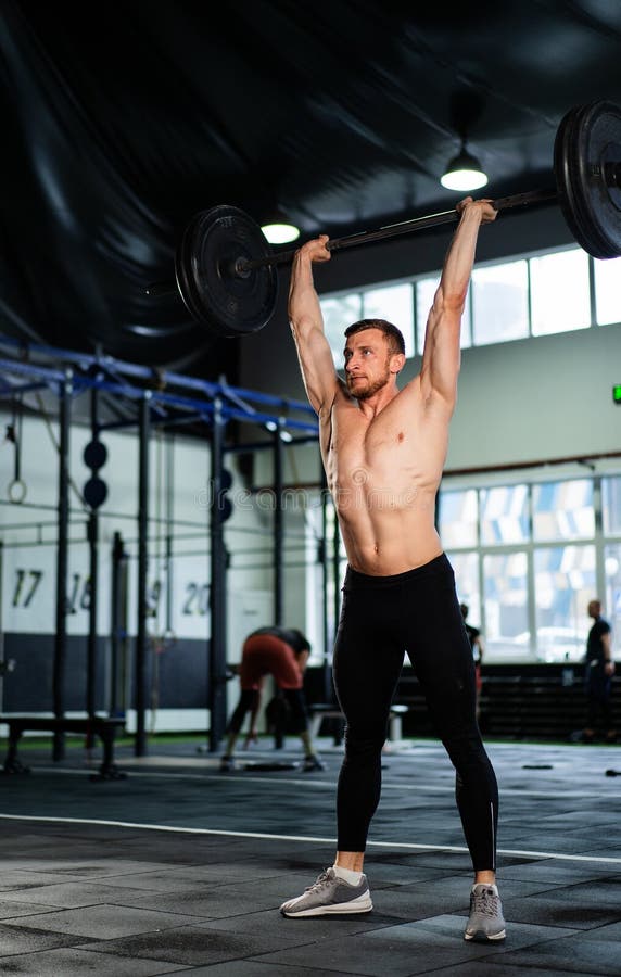 Athletic Man Doing Overhead Barbell Press in Hardcore Gym Stock Image ...