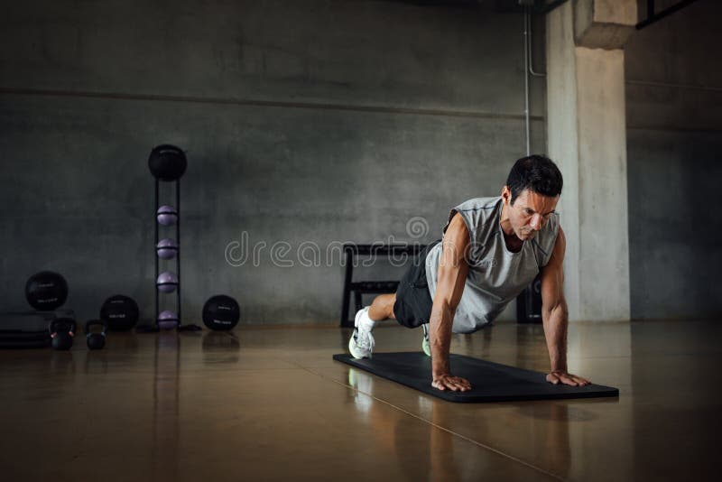 Athletic Man Doing Pushups Exercise at Dark Gym. Stock Image - Image of ...