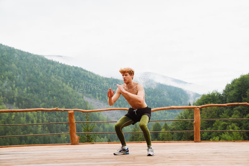 Athletic Man in Doing Squat Exercises during Workout on in Mountains ...