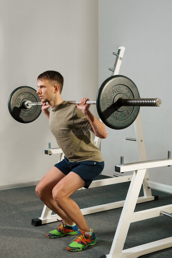 Athletic Man Doing Squats Exercise with Dumbbell Stock Photo - Image of ...