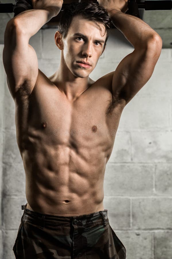 Athletic Man Flexing stock photo. Image of trousers, muscle - 76391892