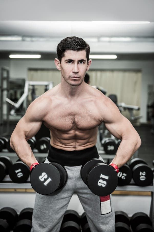 Athletic Man in Gym Working with Dumbbells Stock Image - Image of ...