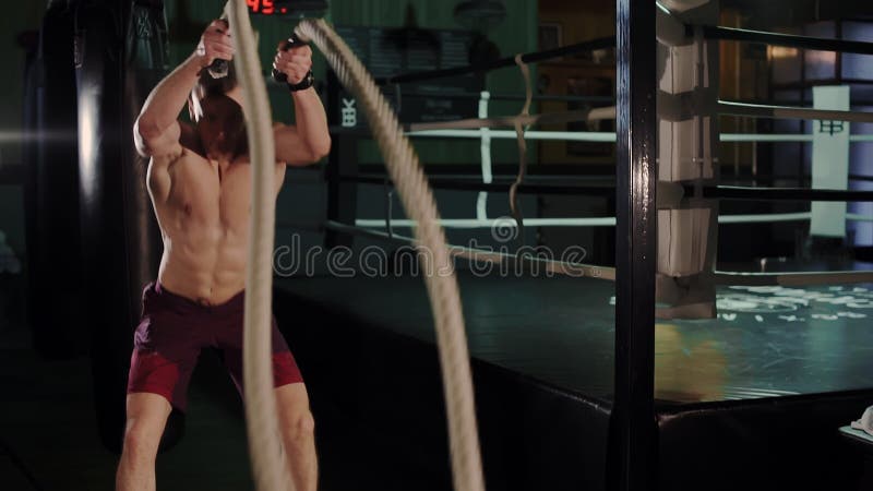 Athletic Man Performing Battle Rope Workout in Gym Stock Footage ...