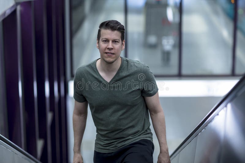 Athletic Man Going Up the Escalator Stock Photo - Image of model ...