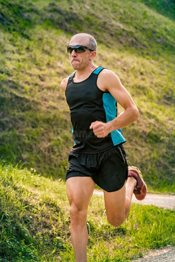 Athletic Man Running in Triathlon on Field Road Stock Photo - Image of ...