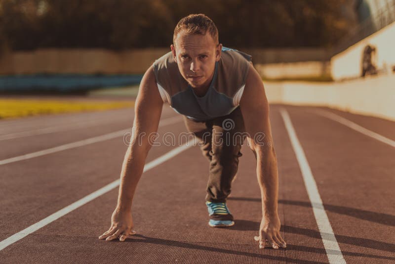 Athletic Man Standing In Posture Ready To Run On A Treadmill Stock ...