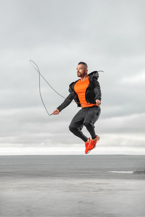 Athletic Man Stretching and Jumping on Morning Run Outdoors Stock Photo ...