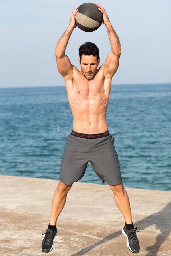 Athletic Man Throwing Medicine Ball Stock Photo - Image of dynamic ...