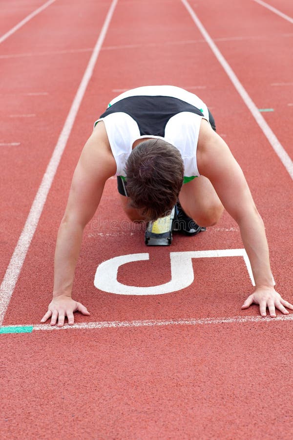 Young Woman Athlete at Starting Position Ready To Start a Race. Stock ...