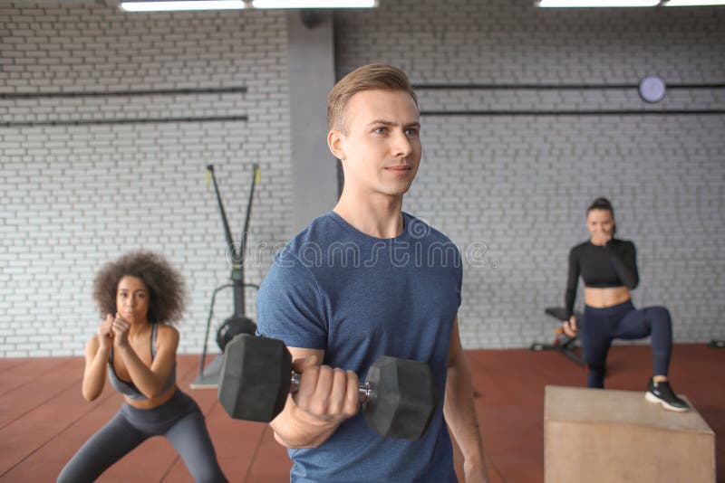 Athletic Man Doing Exercise with Dumbbell in Modern Gym Stock Image ...