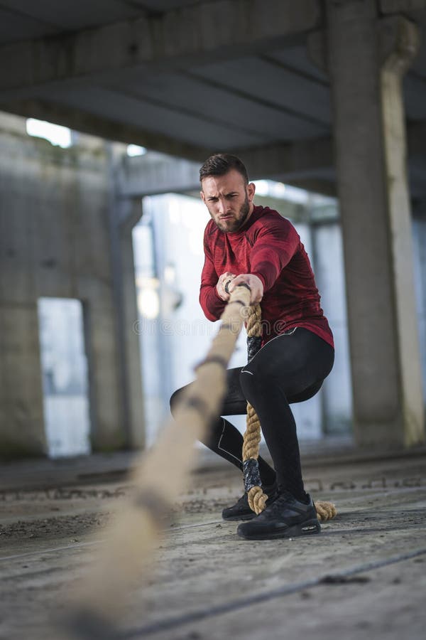 Man pulling battle ropes stock photo. Image of battle - 151393588