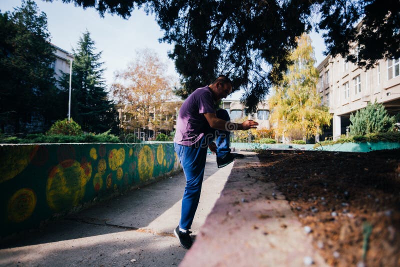 Athletic Parkour Guy Doing Back Flip and Tricks while Jumping Off and ...