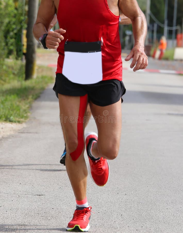 Athletic Runner with Long Muscular Legs during the Foot Race Stock ...