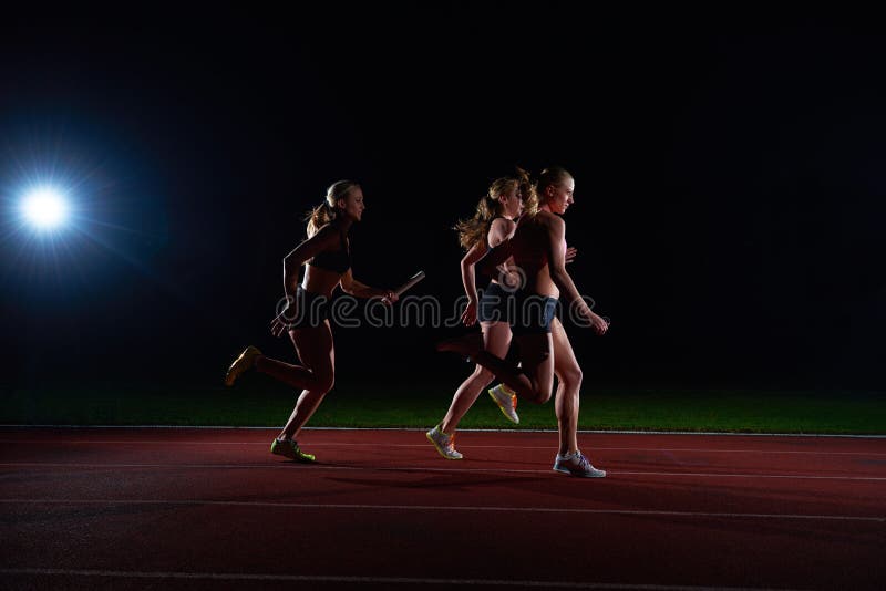 Athletic Runners Passing Baton in Relay Race Stock Photo - Image of ...
