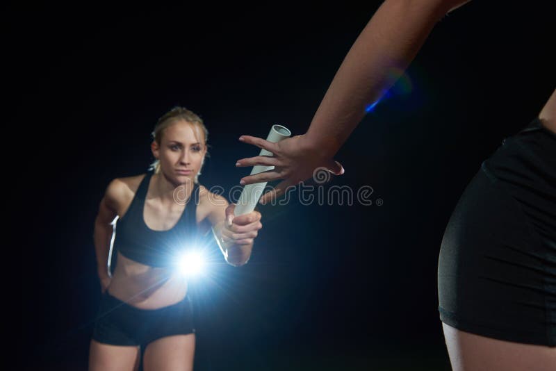 Athletic Runners Passing Baton in Relay Race Stock Photo - Image of ...