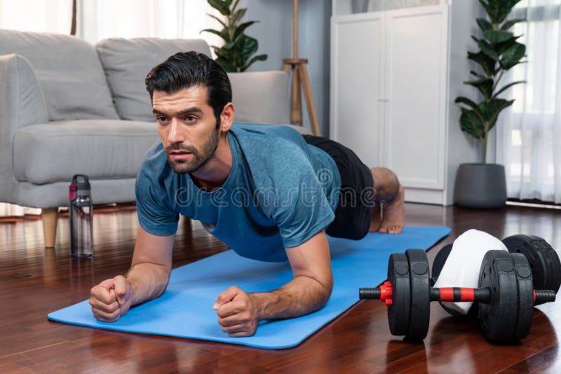 Athletic And Sporty Man Doing Plank On Fitness Mat At Gaiety Home