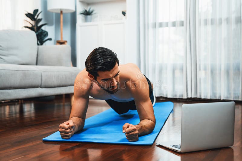 Athletic And Sporty Man Doing Plank On Fitness Mat At Gaiety Home