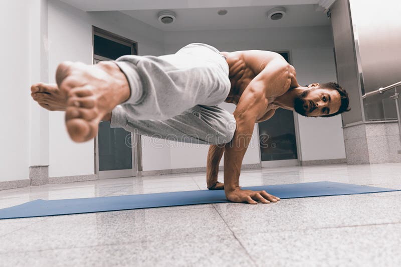 Athletic Strong Man Practicing Difficult Yoga Pose. Stock Photo - Image ...