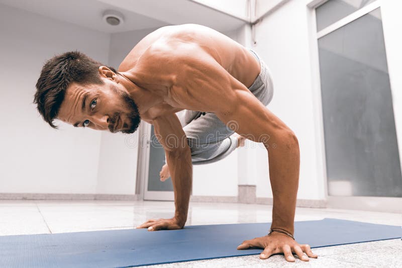 Athletic Strong Man Practicing Difficult Yoga Pose. Stock Photo - Image ...