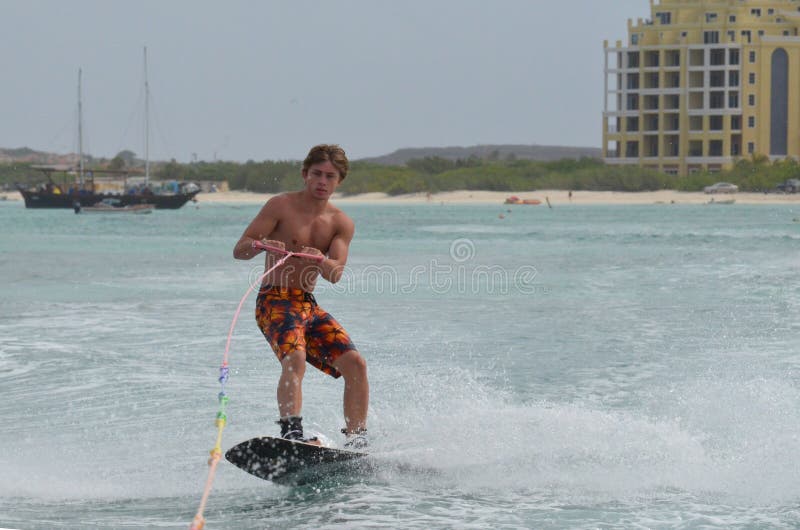 Athletic Wakeboarder Riding a Wakeboard Off the Coast of Aruba Stock ...