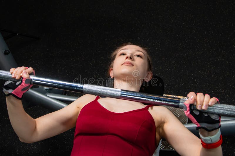 Athletic Woman Doing Barbell Bench Press on a Bench in the Gym Stock ...