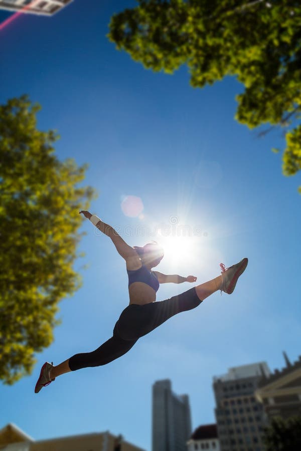 Athletic Woman Jumping in the Air and Doing Split Stock Image - Image ...