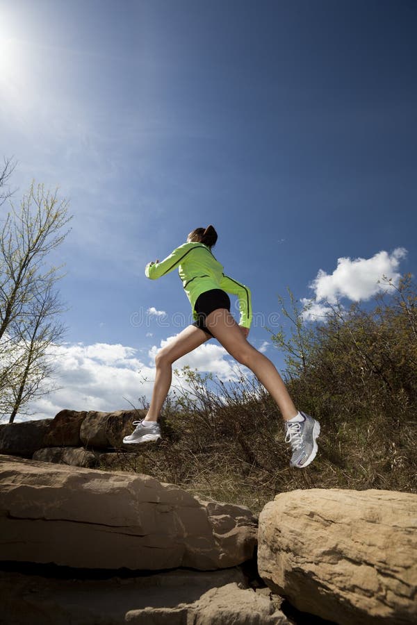 Athletic Woman Jumping while Jogging Stock Photo - Image of lifestyle ...