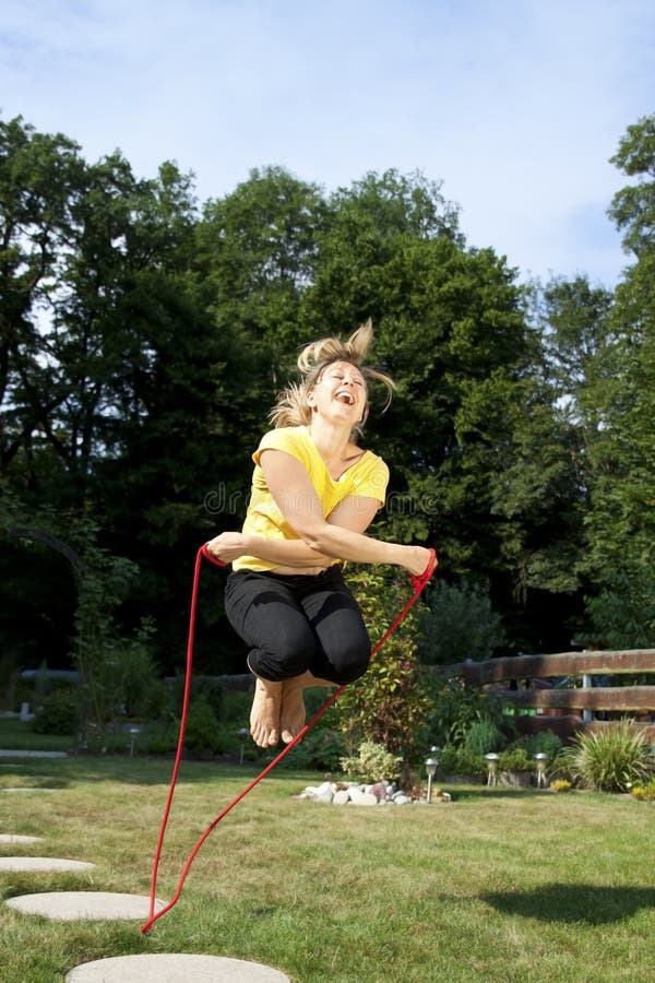 Athletic Woman Jumping Rope in the Garden Stock Photo - Image of blond ...