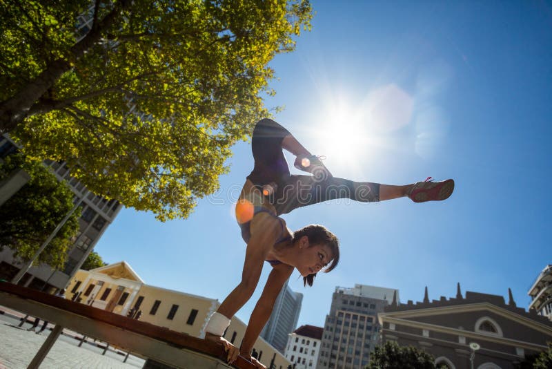 Athletic Woman Performing Handstand on Bench Stock Photo - Image of ...