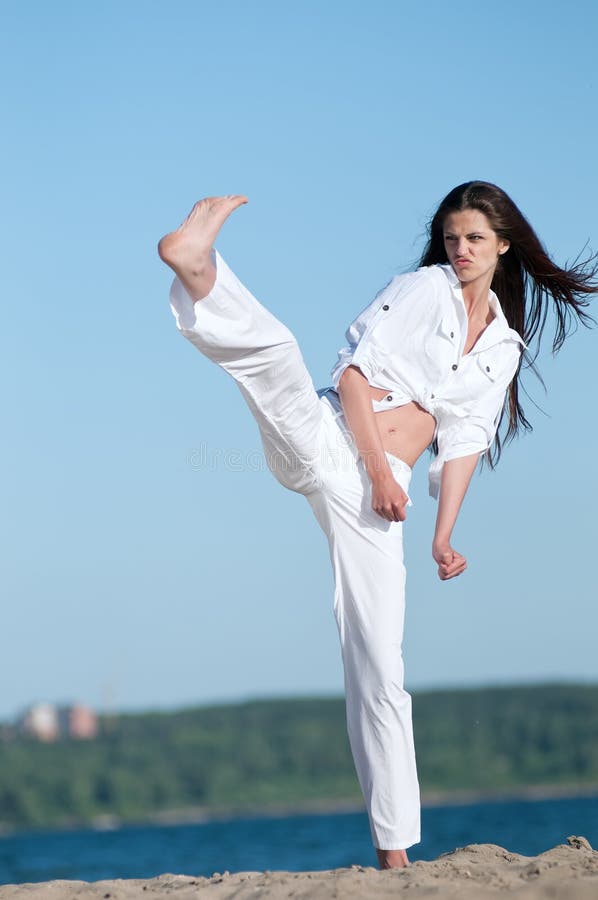 Athletic Woman Performing a Kick Stock Photo - Image of defend, arts ...