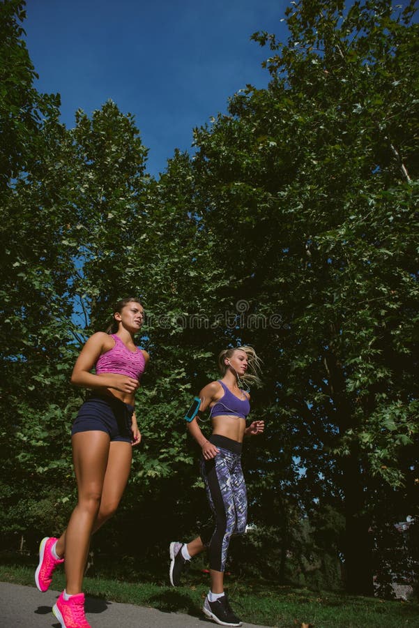 Athletic Women Exercising by Jogging in Nature Stock Photo - Image of ...
