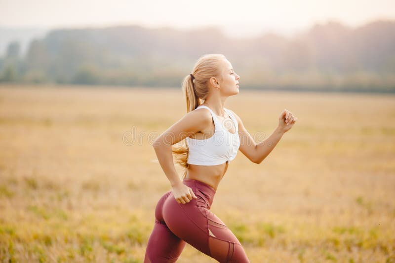 Athletic Young Blonde Girl Is Jogging In Park Dawn Concept Running For