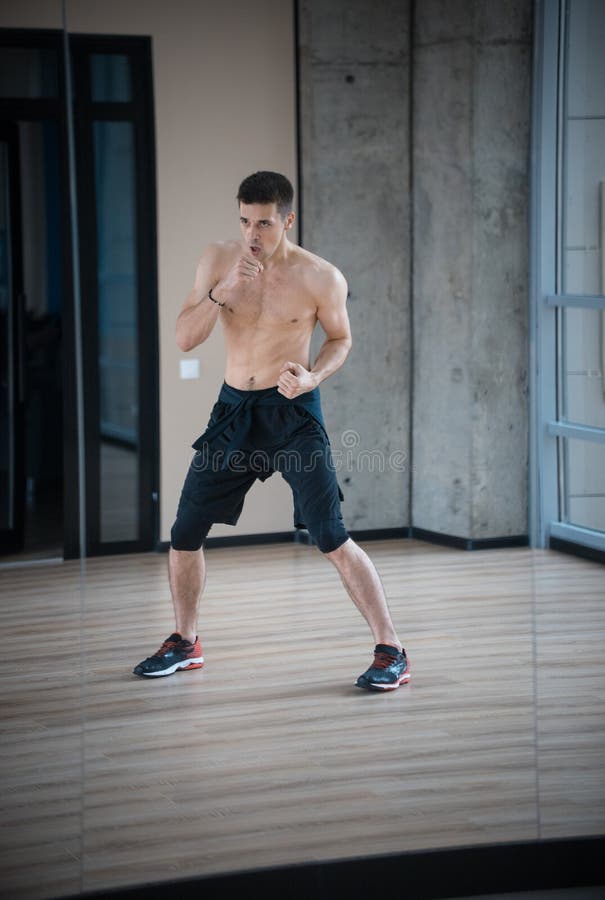 An Athletic Young Man Boxer Standing in Fighting Pose in the Bright ...