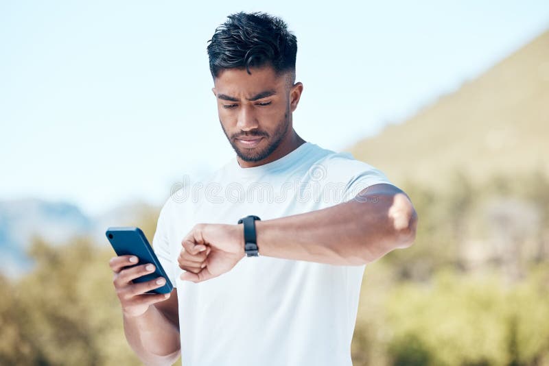 Athletic Young Man Checking His Watch after a Hike Outdoors. Resting ...
