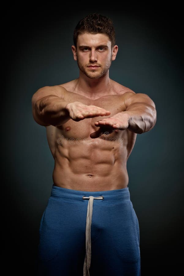 Athletic Young Man Exercising Stock Photo - Image of expression, adult ...