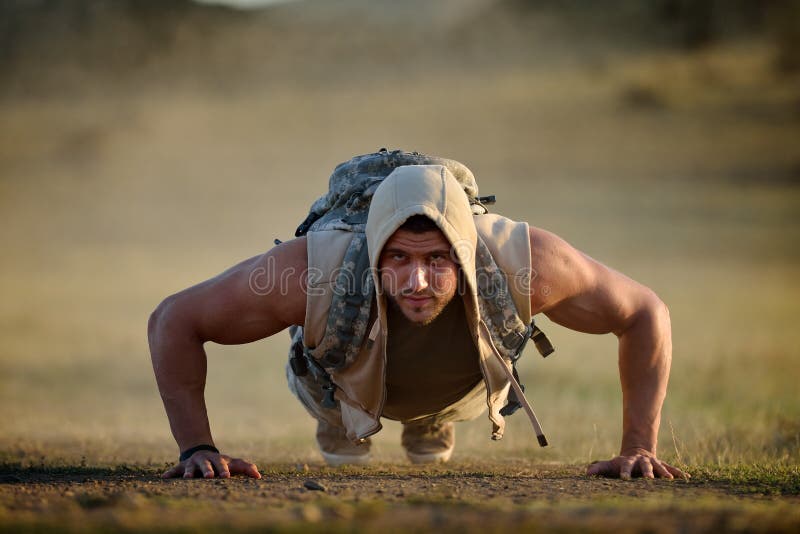 Athletic Young Man Exercising Outdoor on Dusty Field Stock Photo ...