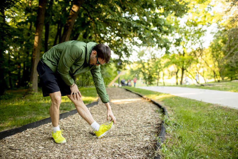 Athletic Young Man Having a Break while Doing Workout in Sunny Green ...