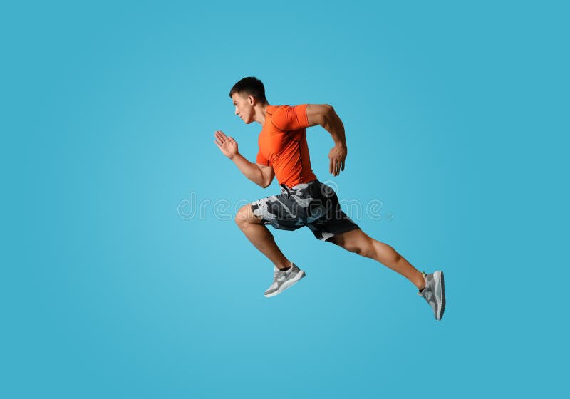 Athletic Young Man Running on Light Blue Background Stock Image - Image ...