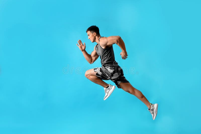 Athletic Young Man Running on Light Blue, Side View Stock Photo - Image ...