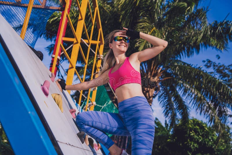 Athletic Young Woman Working Out and Climbing at the Artificial Rock in ...