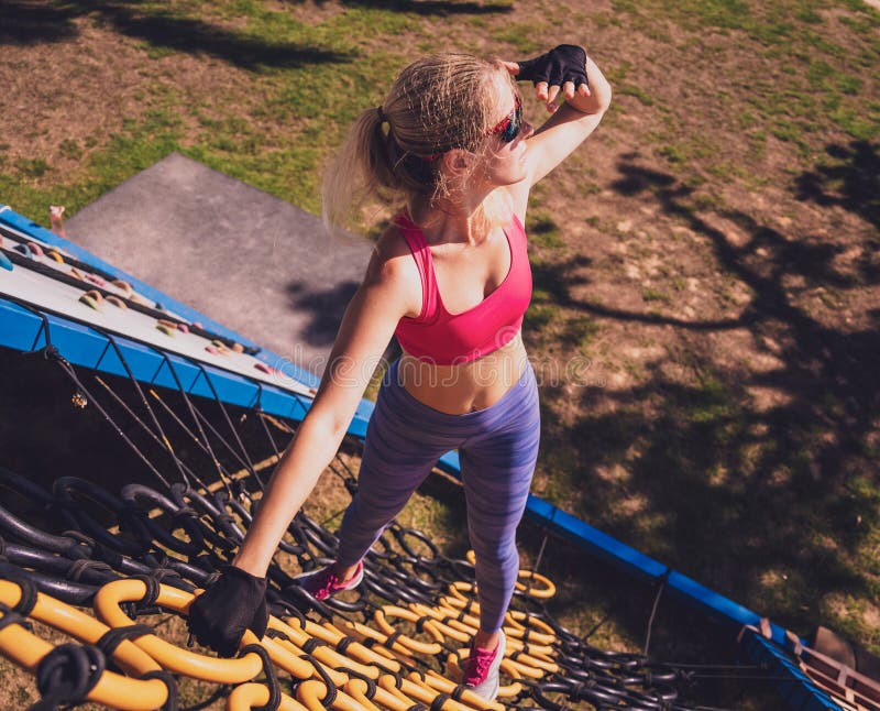 Athletic Young Woman Working Out and Climbing a Ropes at the Rope ...