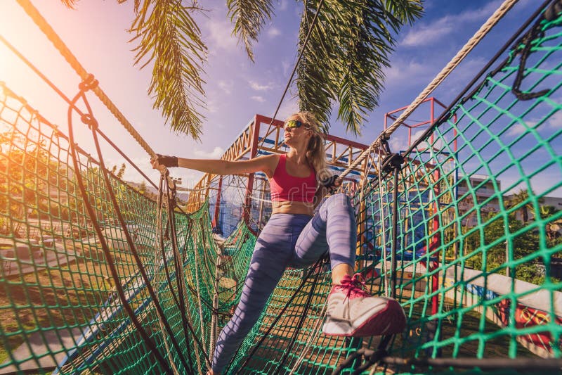 Athletic Young Woman Working Out at the Rope Training Camp. Stock Image ...