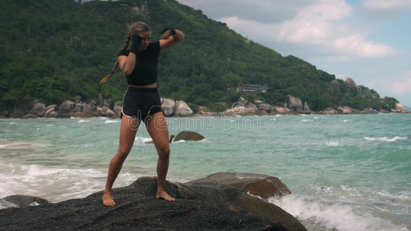 Athletically Built Female Practicing the Correct Hook while Standing on ...